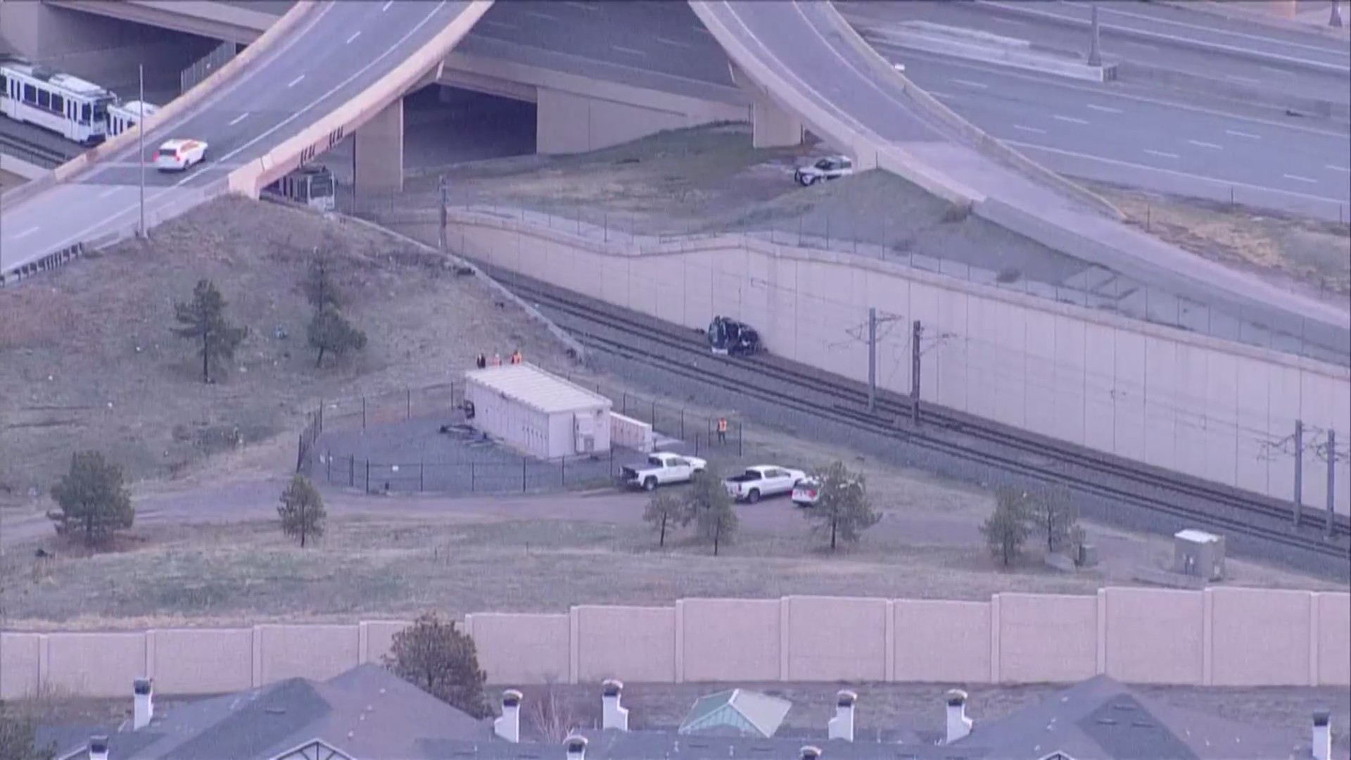 1 dead after car drives off overpass, crashes with light rail train ...