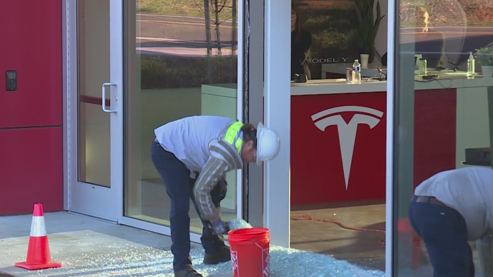 Shattered windows, bullet holes discovered at Tesla dealership in ...