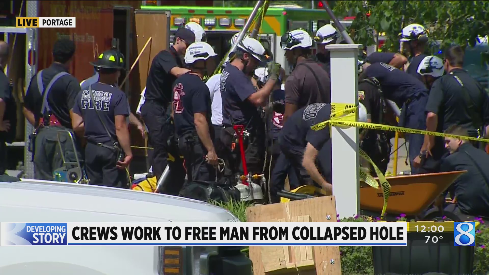 Crews work to free man from collapsed hole – WOODTV.com